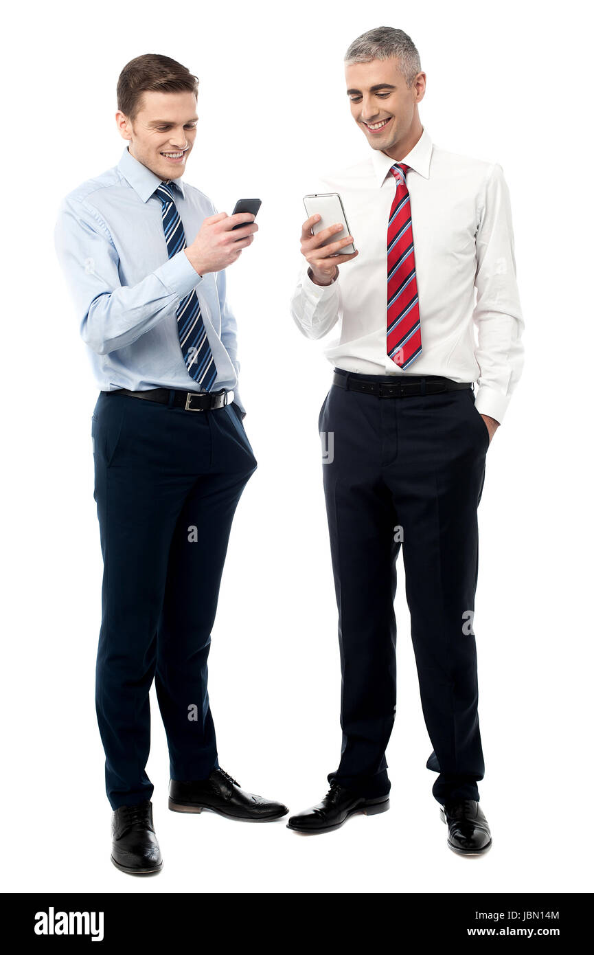 Smiling business people exchanging their mobile numbers Stock Photo - Alamy
