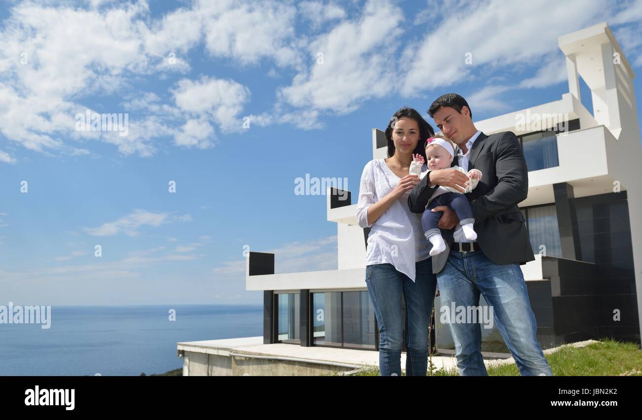 happy young family couple with beautiful new born baby have fun at home ...