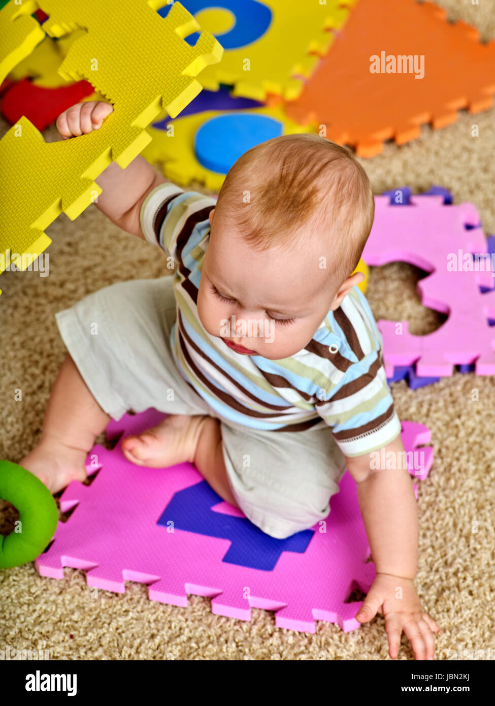 Child jigsaw develops children. Family puzzle making baby. Portrait of ...