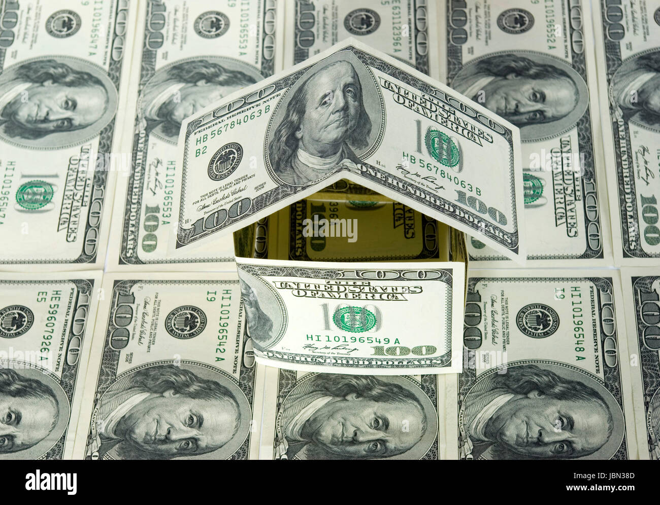 Money house on dollars background Stock Photo - Alamy