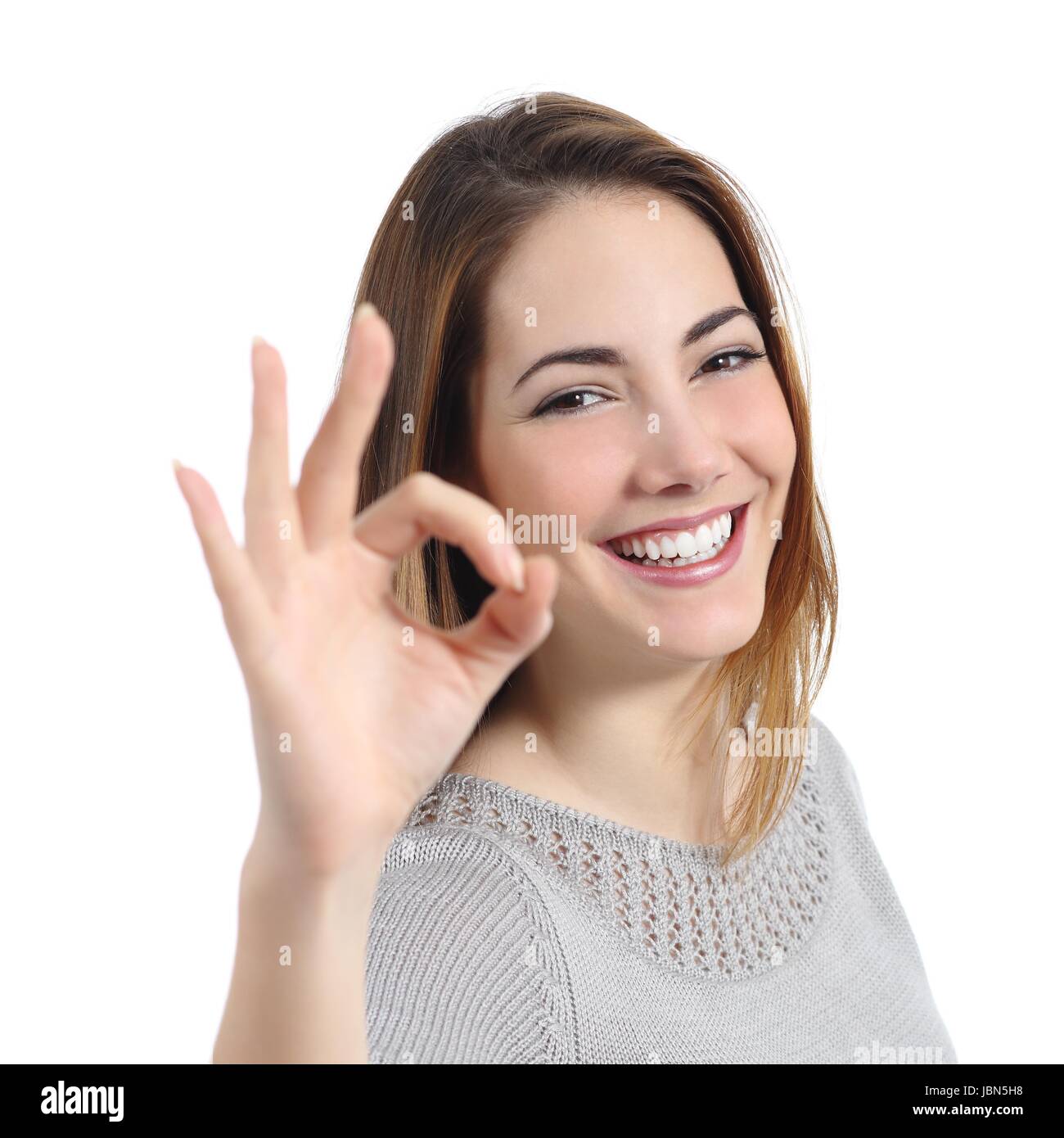 Close up of a happy woman with perfect smile gesturing ok isolated on a ...