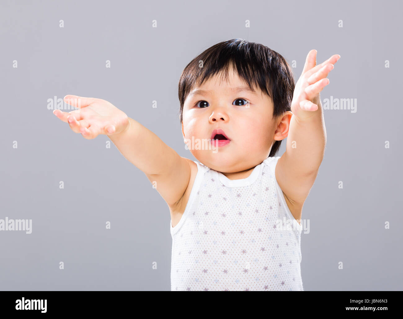 Baby boy raised two hand Stock Photo - Alamy