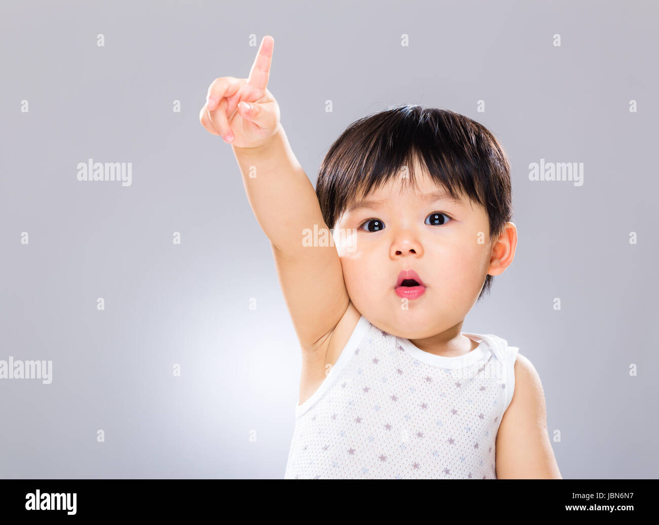 Adorable boy hand raised up Stock Photo - Alamy