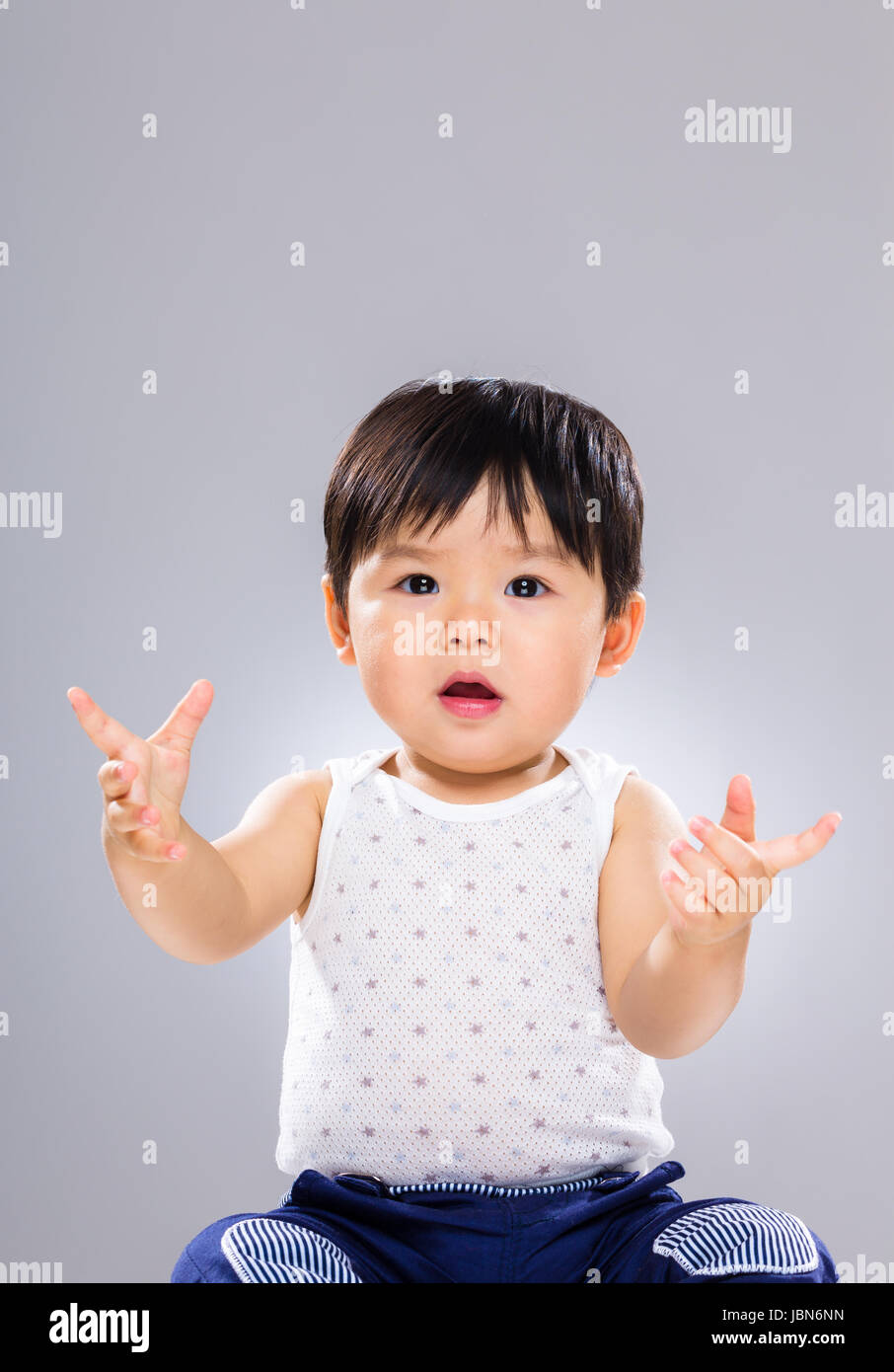 Little boy hand raised up Stock Photo - Alamy