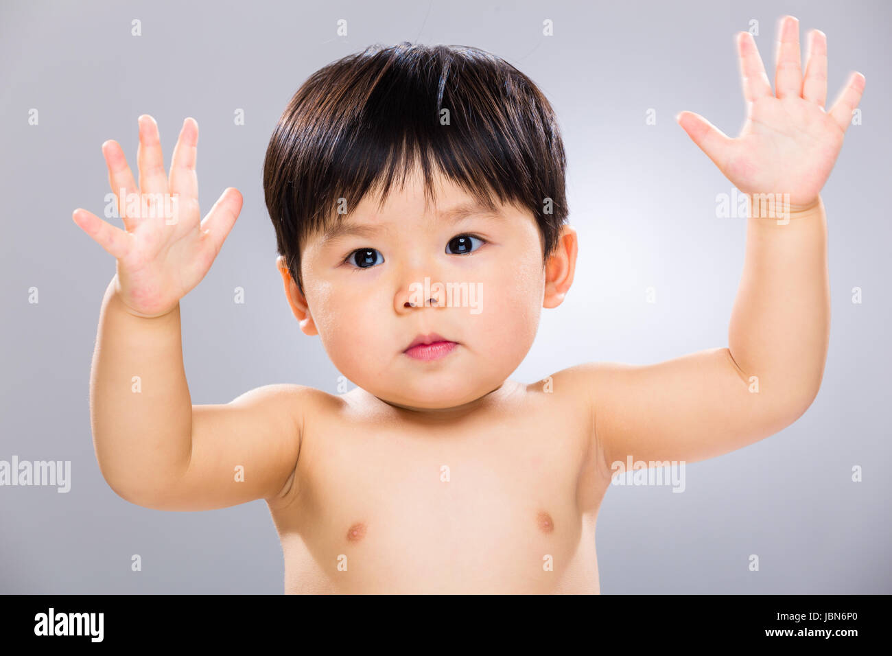 Little baby raised two hand Stock Photo - Alamy