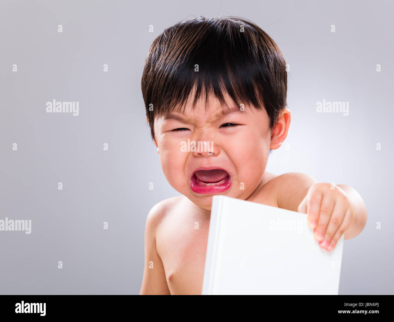 Little boy hate reading book Stock Photo - Alamy