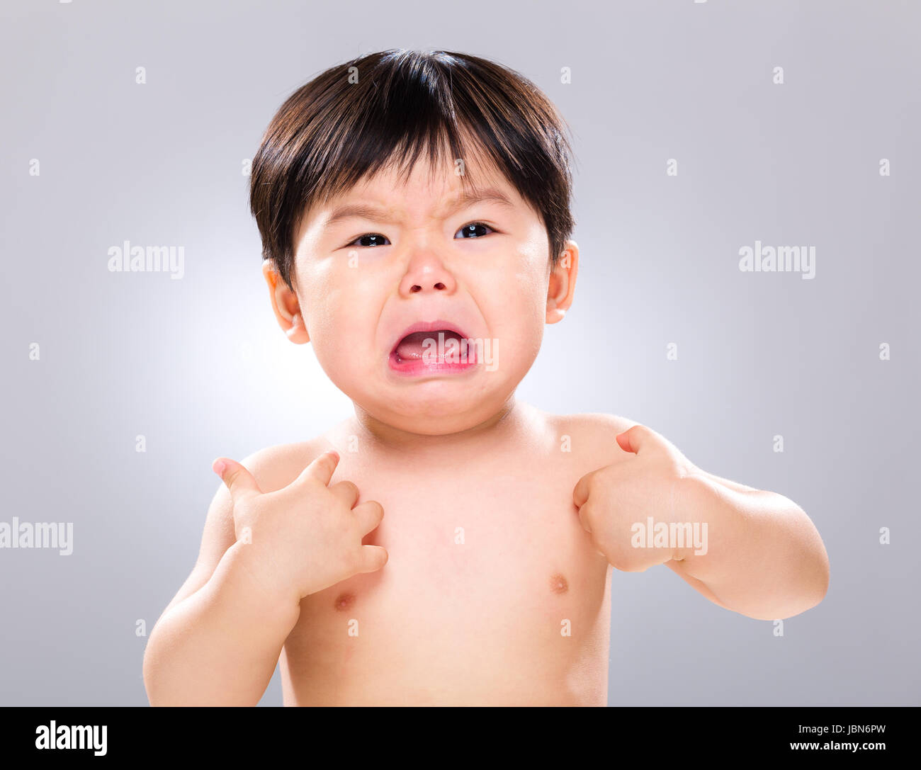 Crying baby with scratching his body Stock Photo - Alamy