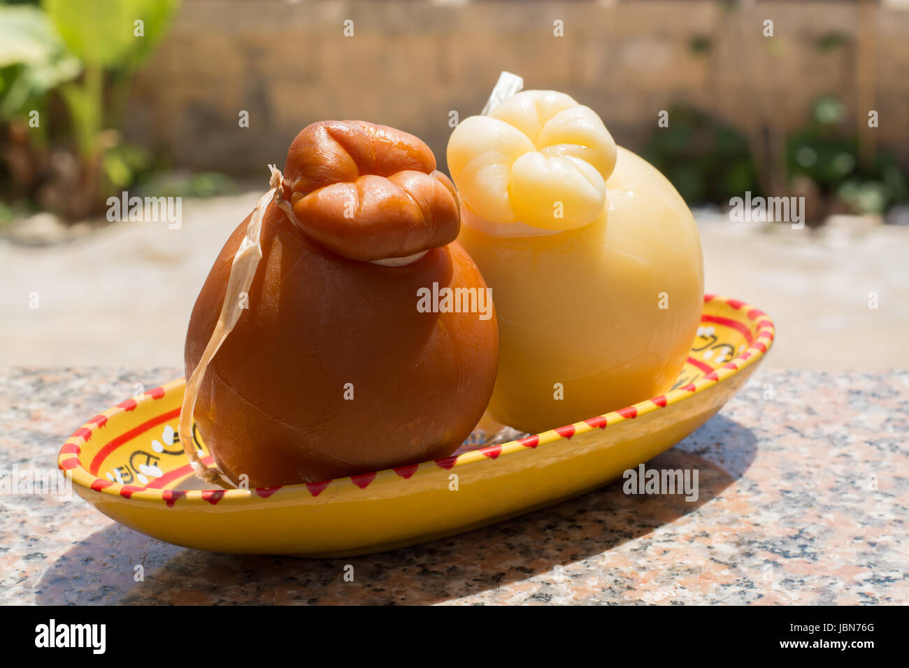 Traditional Italian hard cheese Provolone of Caciocavallo, white and ...