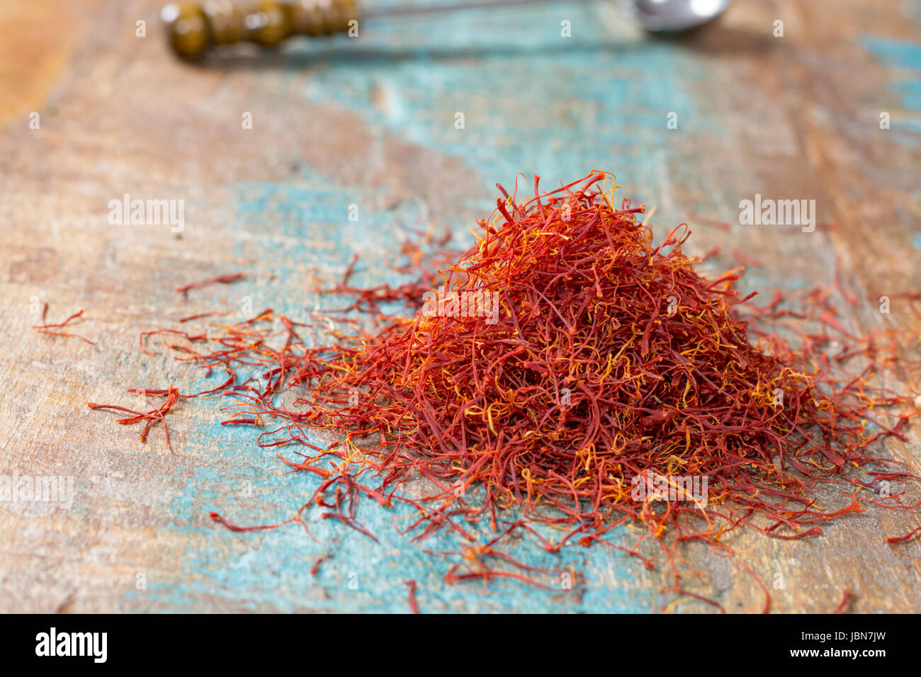 Dried organic red saffron Spice on wooden background with spoon Stock ...