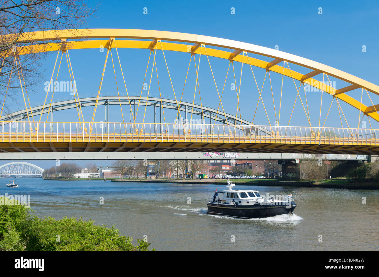 yellow arch bridge in Utrecht, netherlands. The Hogeweide Bridge is a ...