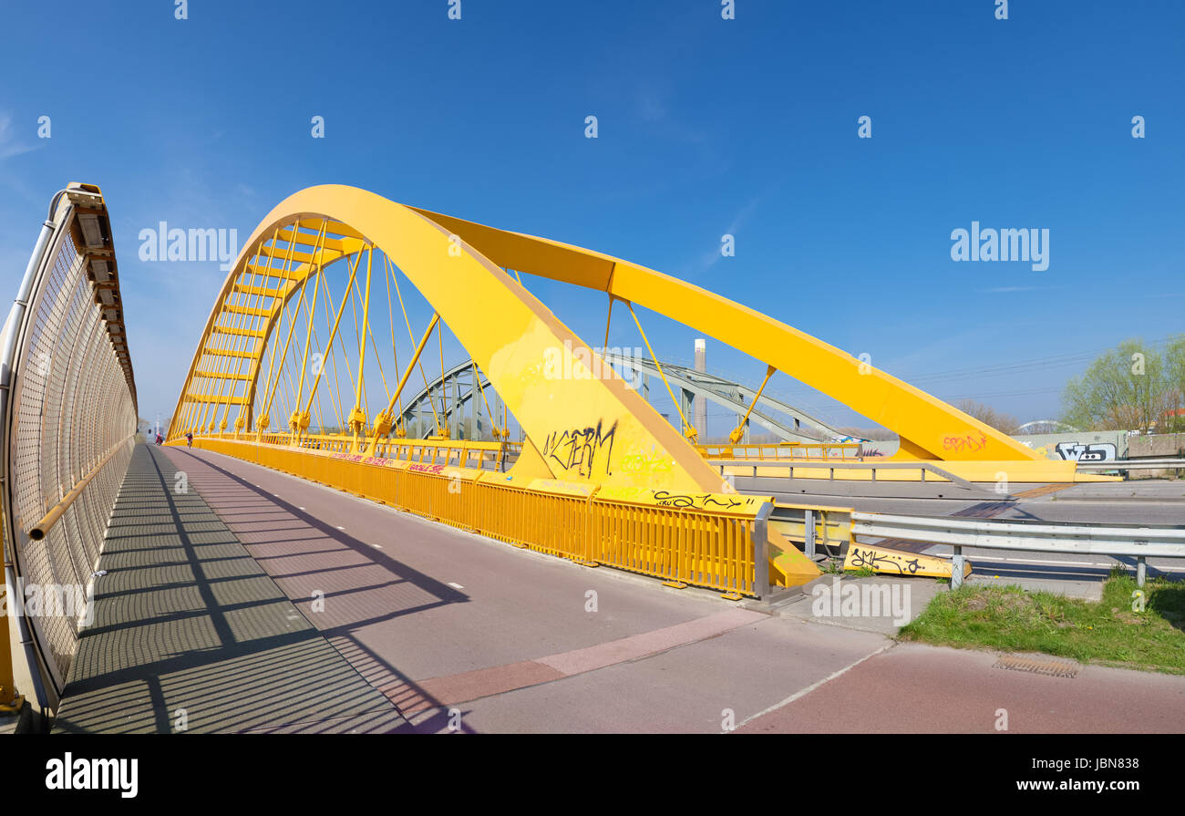 yellow arch bridge in Utrecht, netherlands. The Hogeweide Bridge is a ...
