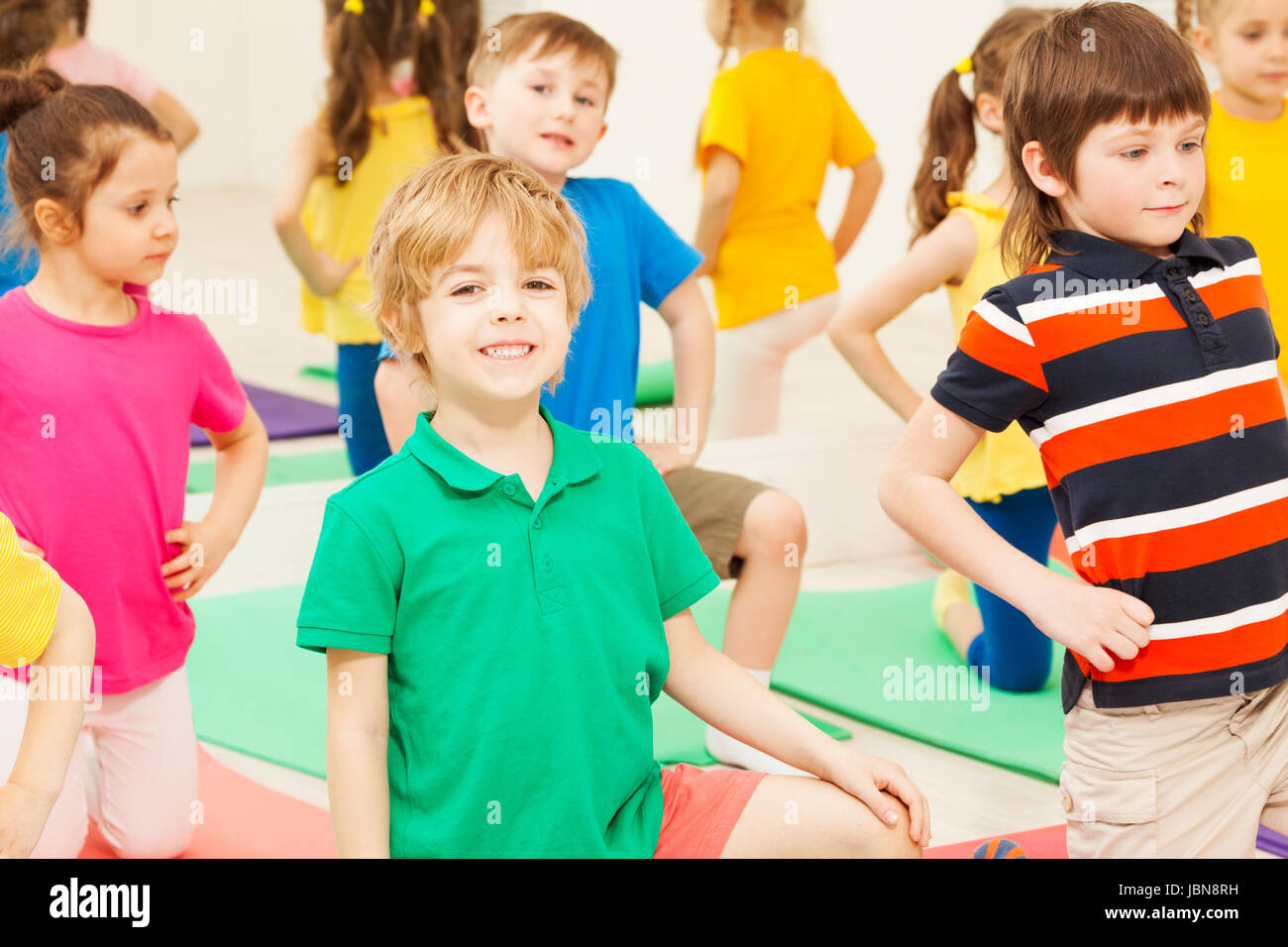 Portrait of happy school girl bending over white background Stock Photo ...