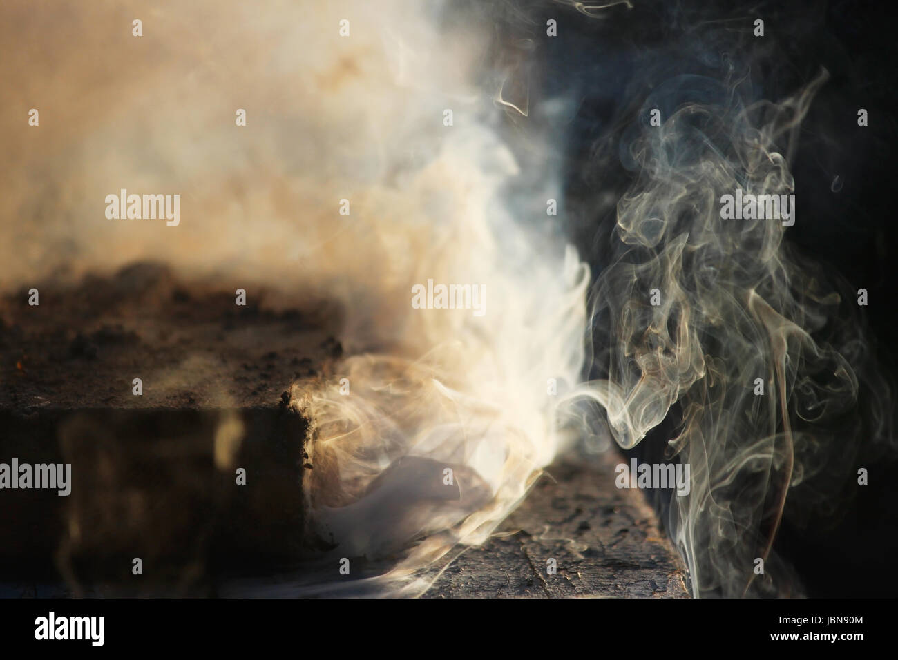 White smoke from the fire where wet boards and sawdust lie Stock Photo ...