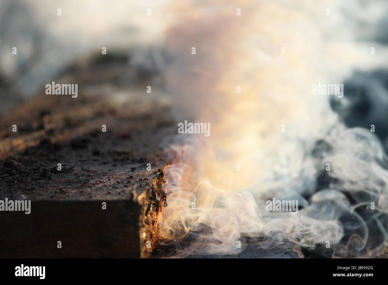 White smoke from the fire where wet boards and sawdust lie Stock Photo ...
