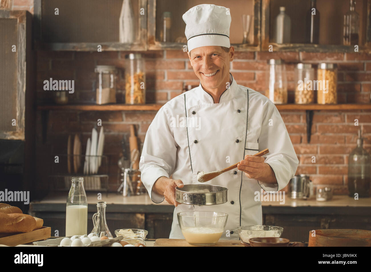 Bakery chef cooking bake in the kitchen professional Stock Photo - Alamy