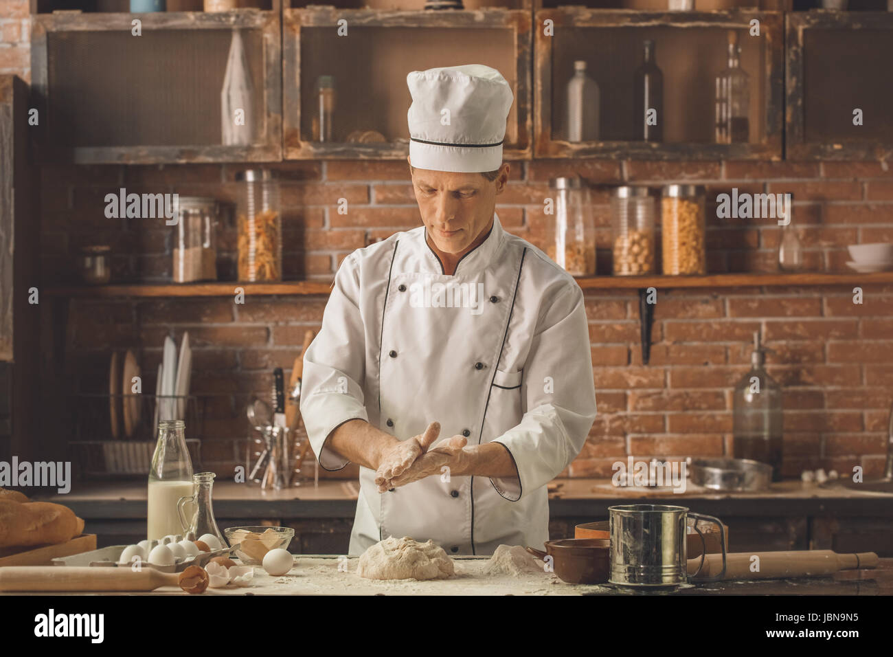 Bakery chef cooking bake in the kitchen professional Stock Photo - Alamy