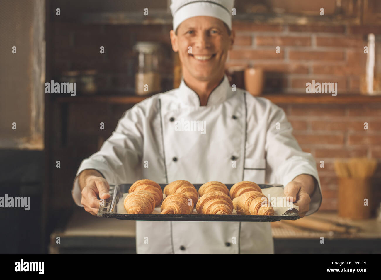 Bakery chef cooking bake in the kitchen professional Stock Photo - Alamy