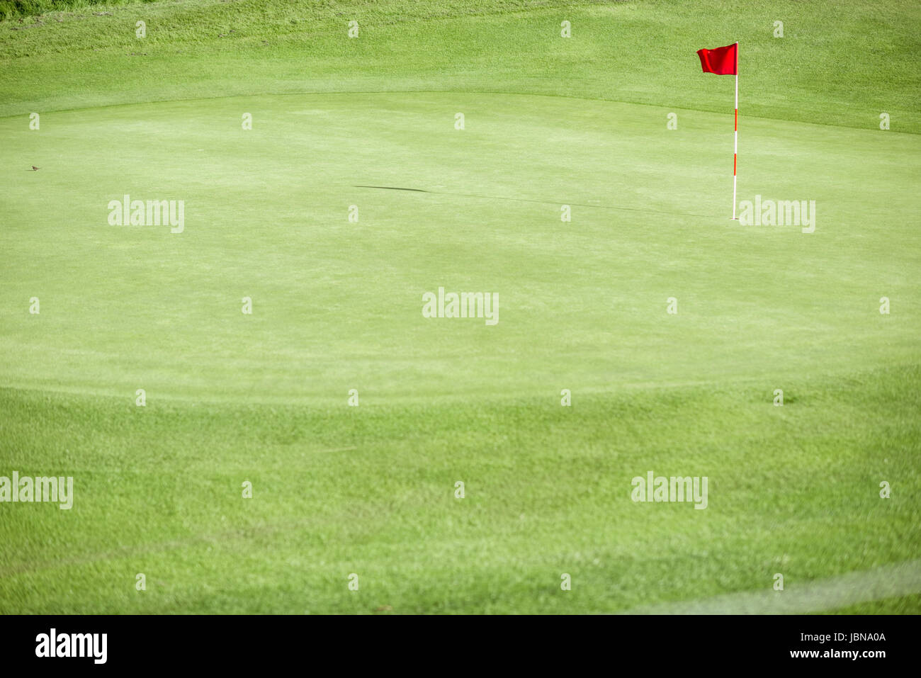 Golf field with hole and flag Stock Photo - Alamy
