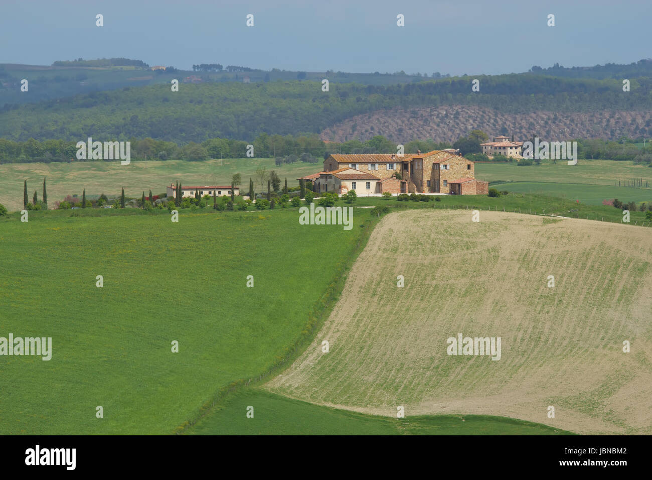 View of Tuscany landscape with farm surrounded by fields Stock Photo ...