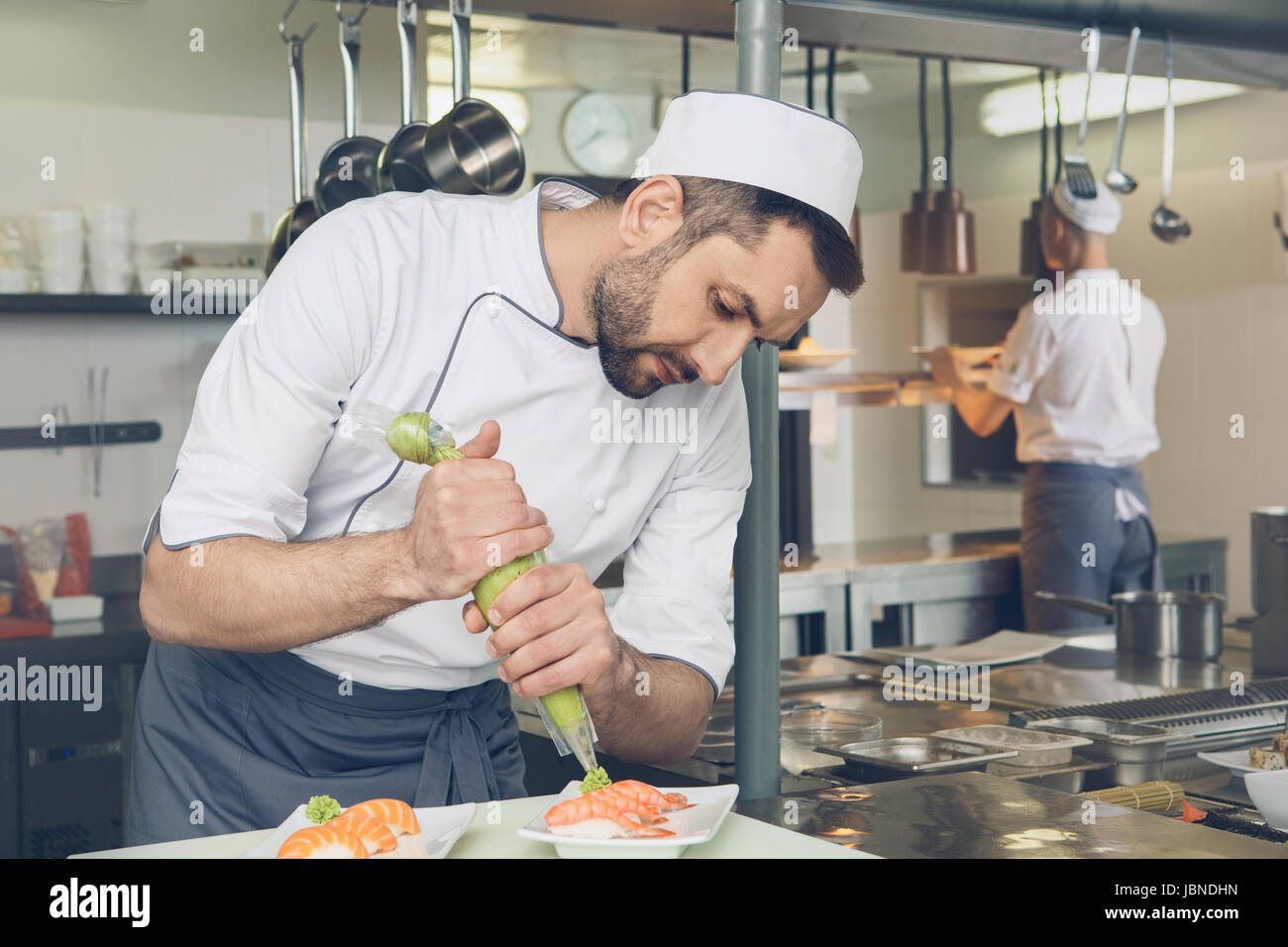 Man japanese restaurant chef cooking in the kitchen Stock Photo - Alamy