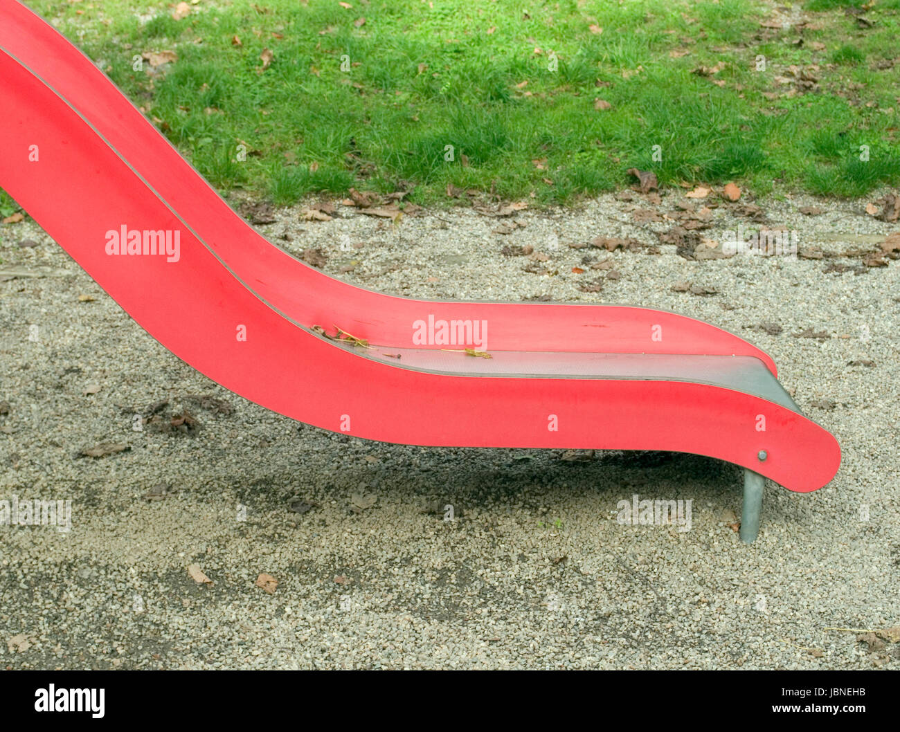 red slide in a public park Stock Photo - Alamy