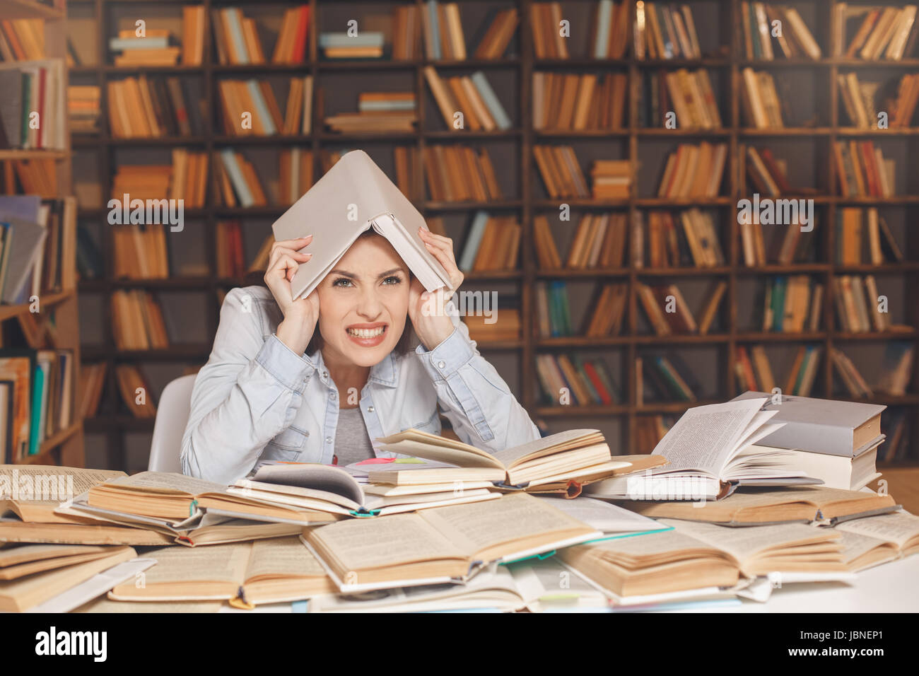 Young woman study in the library alone Stock Photo - Alamy