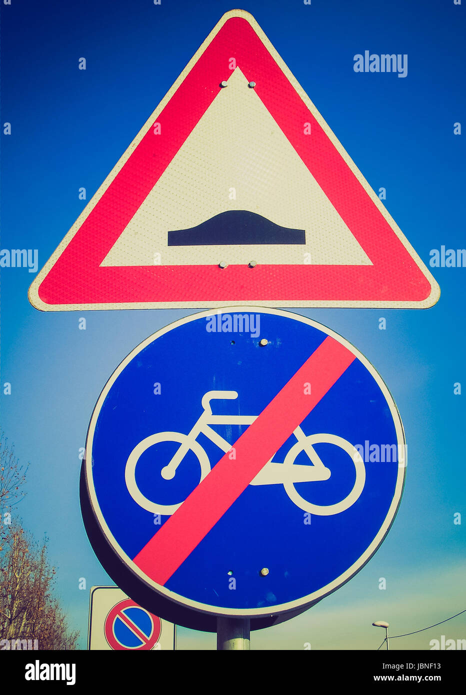 Vintage retro looking Road traffic signs over blue sky Stock Photo - Alamy