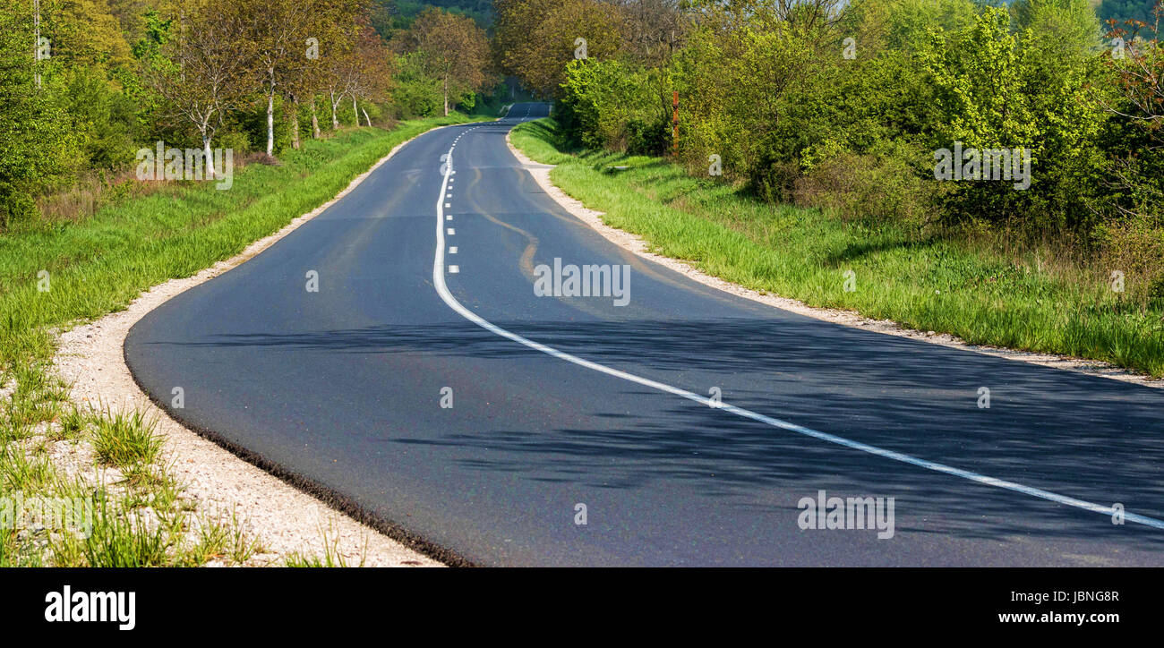 Straight asphalt road leading into the distance Stock Photo - Alamy