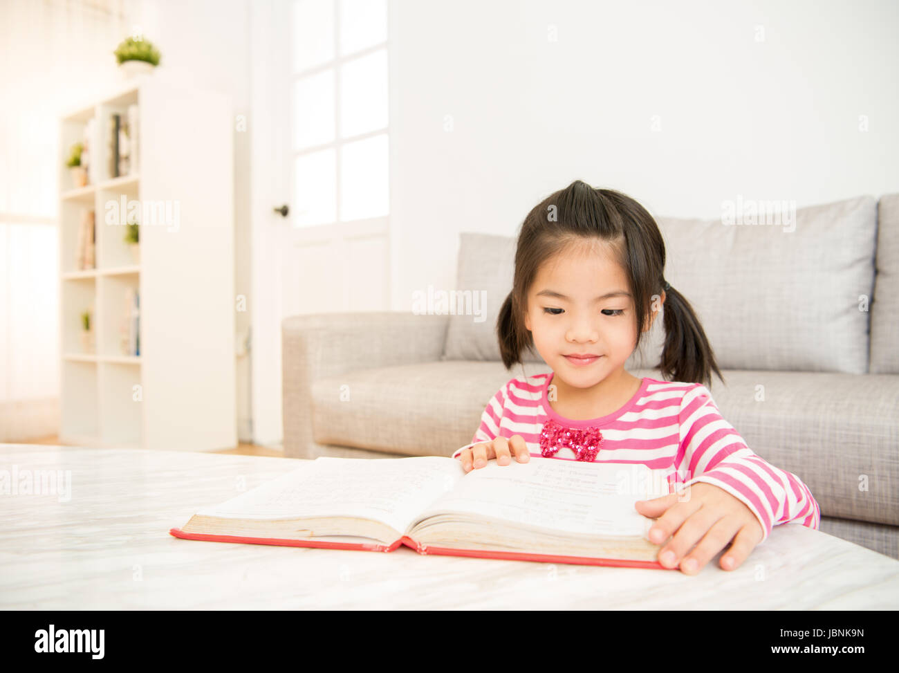 clever asian chinese kids girl at table with reading books in the ...