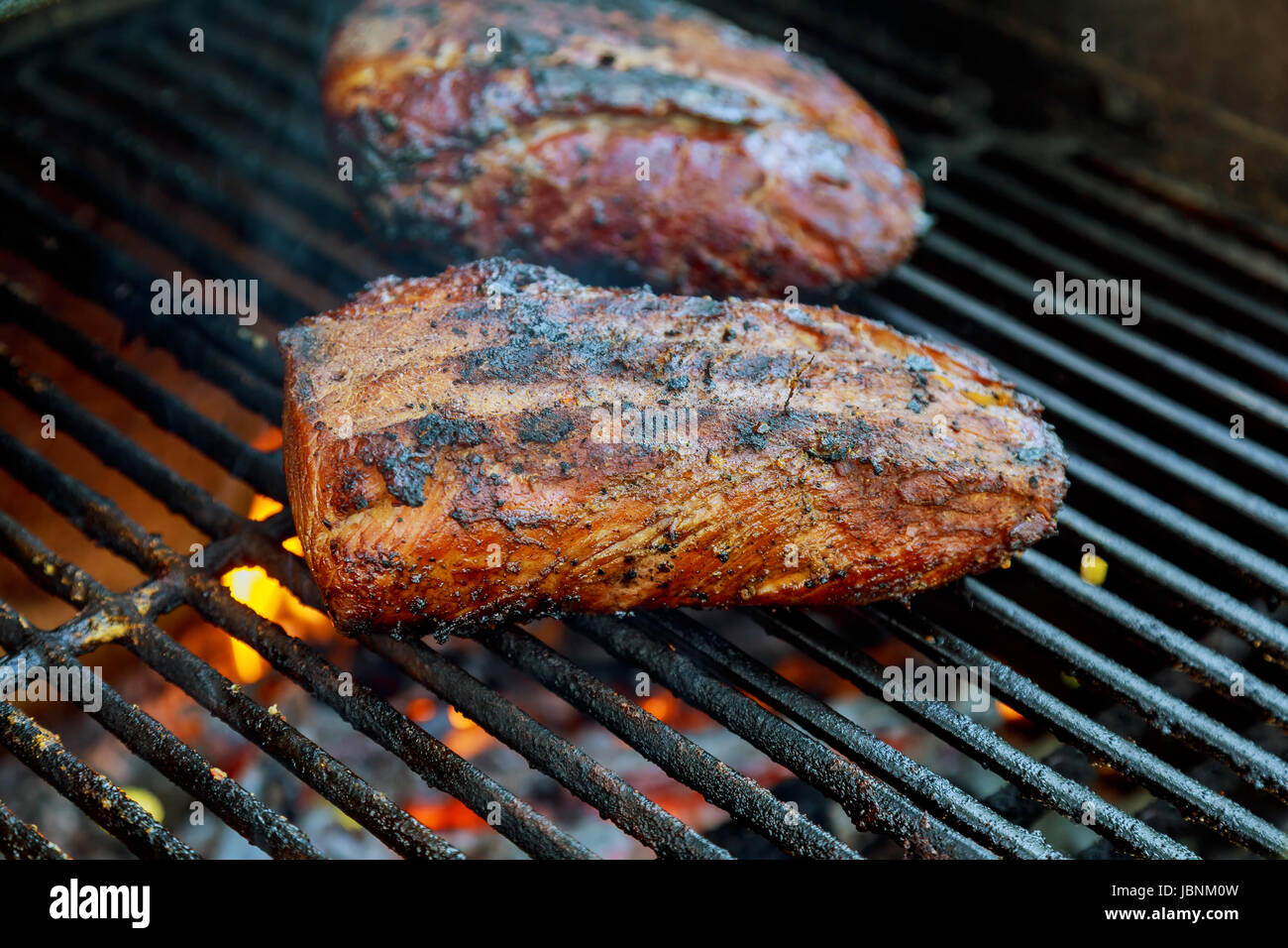 Beef steaks on the grill with flames Steak roasted on fire Stock Photo ...