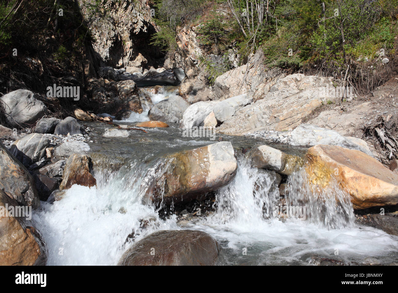 Cascading stream of melting ice and snow in Kananaskis Stock Photo - Alamy