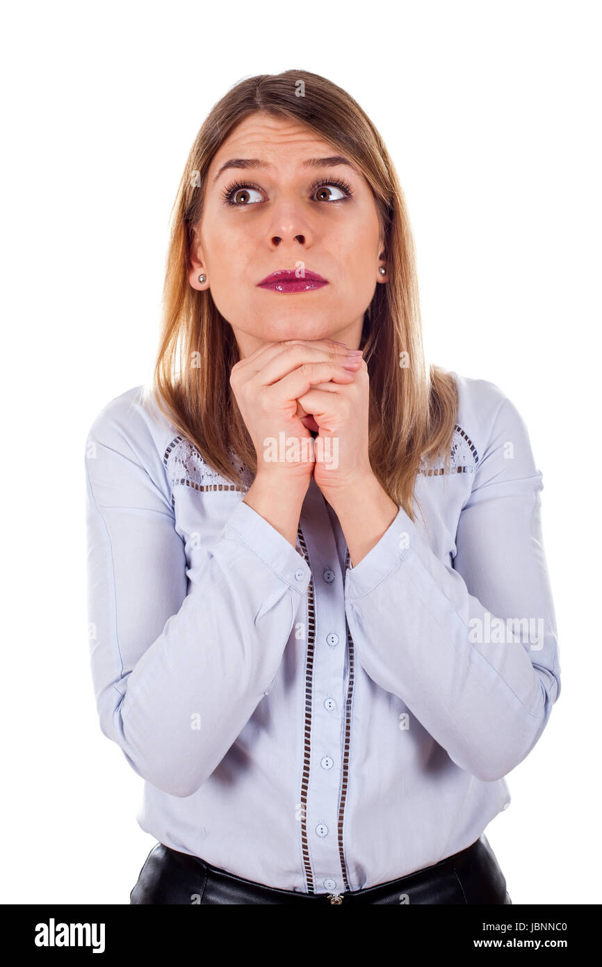 Portrait of a concerned young female holding hands together on isolated ...