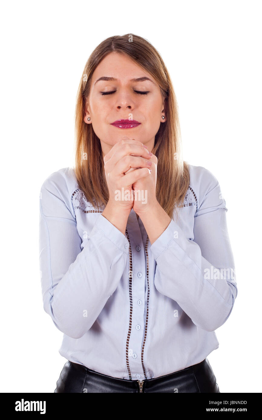 Portrait of a concerned young female holding hands together on isolated ...