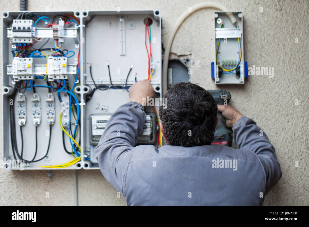 Picture of an electrician fixing an electric fuse at home Stock Photo ...