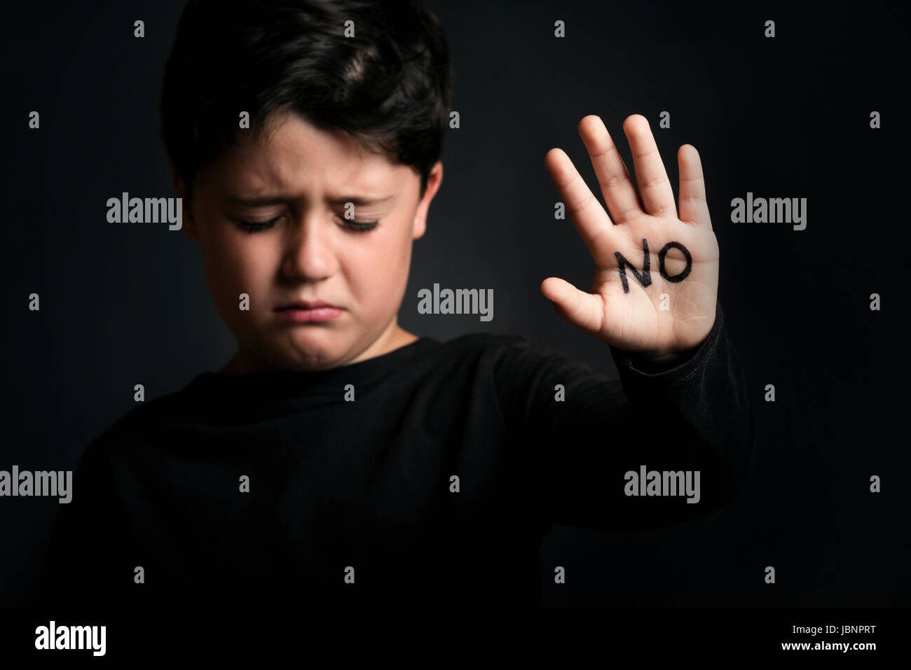 Abused child, child with the word not in his hand Stock Photo - Alamy