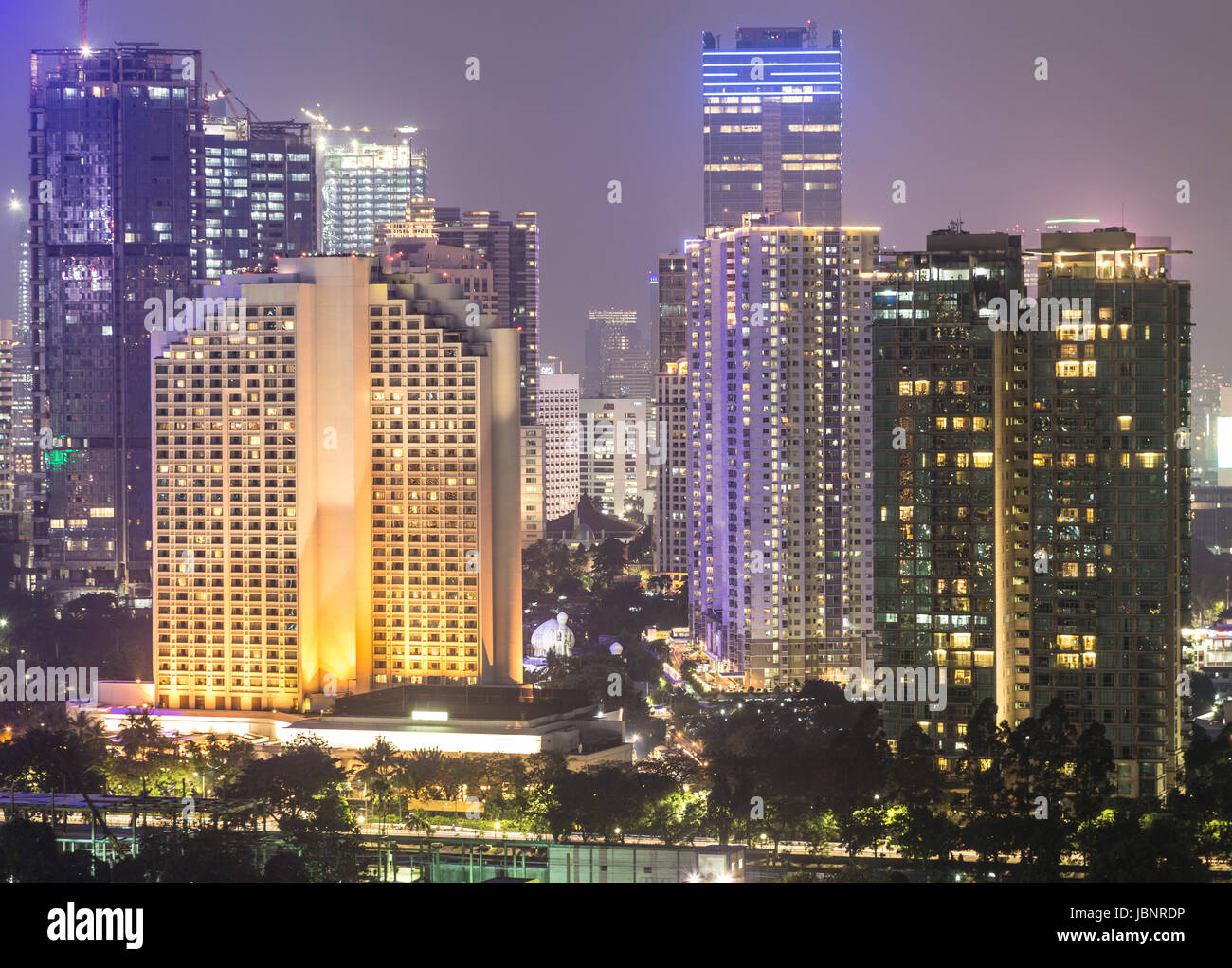 Aerial night view of modern condominium building, office towers and ...