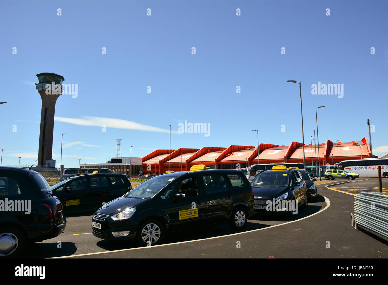 Control tower behind a taxi rank at Luton Airport in Luton Bedfordshire ...