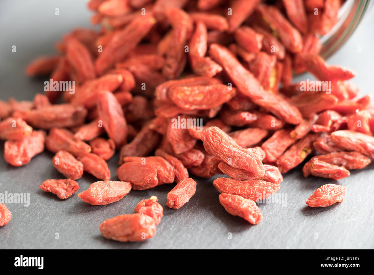 Dried goji berries on a stone background Stock Photo - Alamy