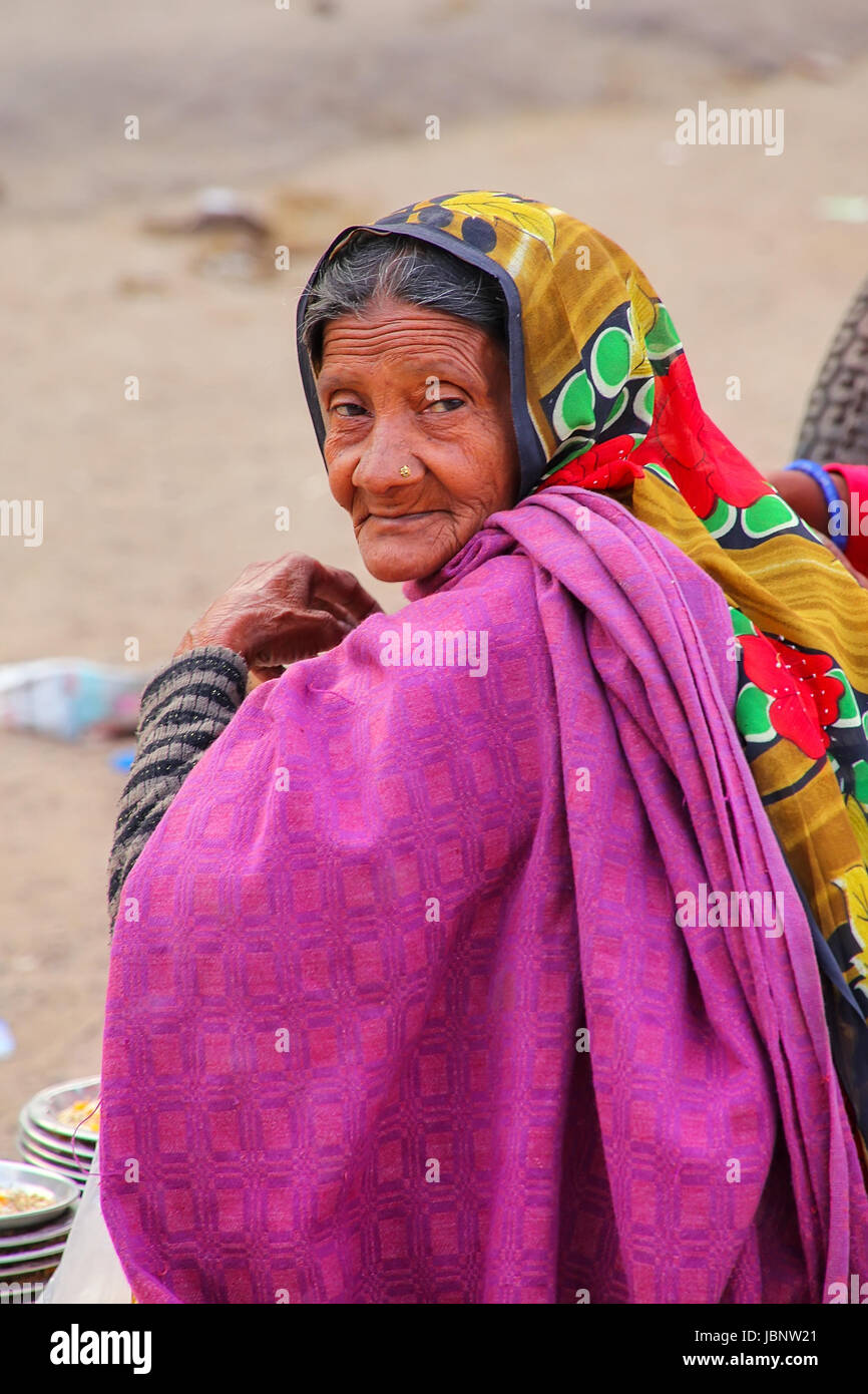 Local woman sitting near Amber Fort, Rajasthan, India. Amber Fort is ...
