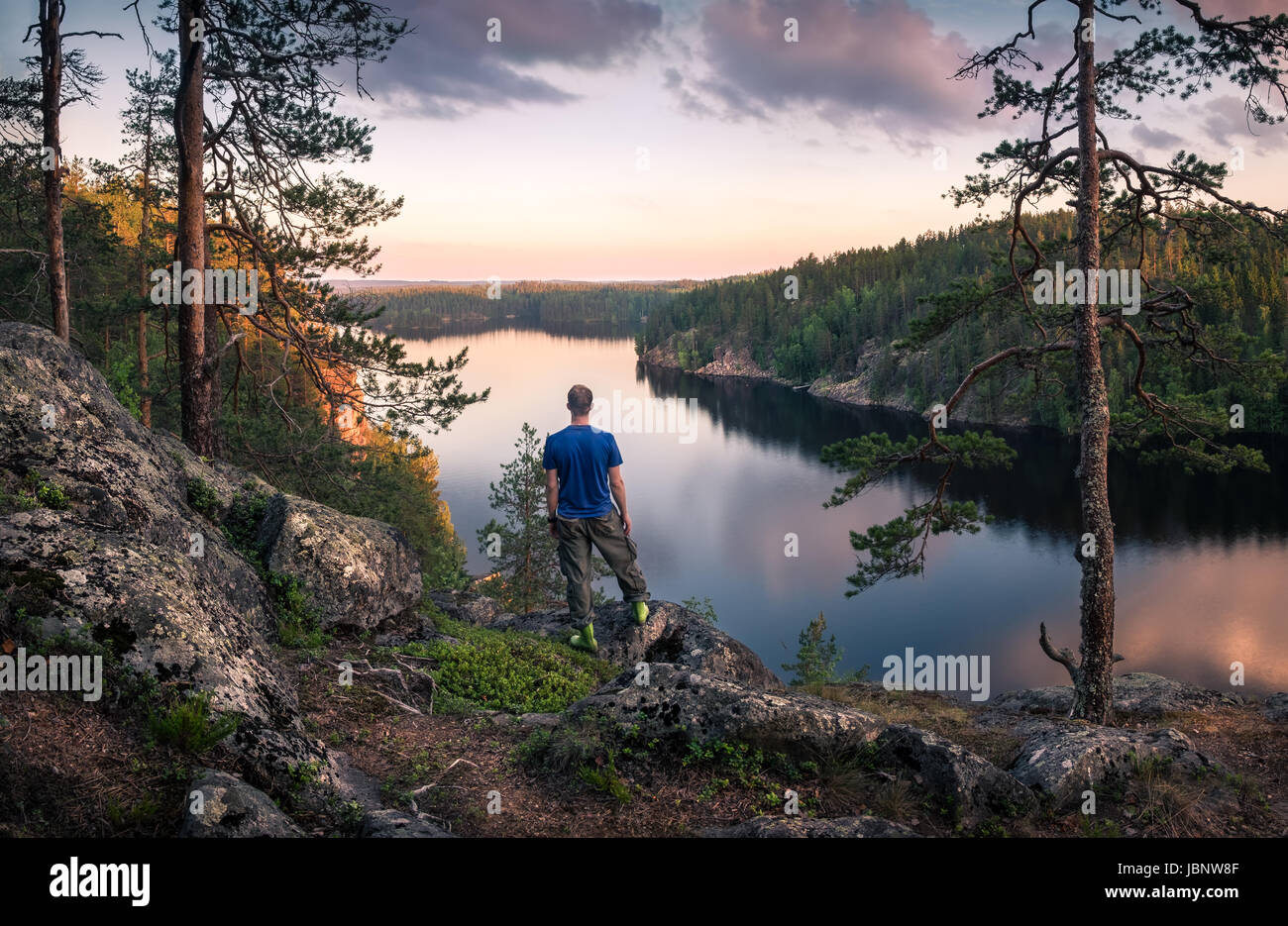 Hiker standing top of the hill front of beautiful idyllic landscape ...