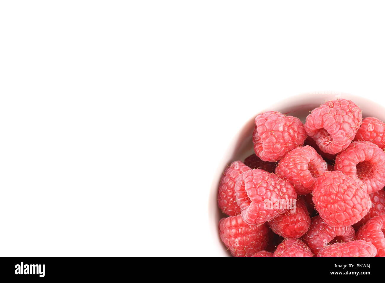 fresh red raspberry fruits in a small white bowl Stock Photo - Alamy
