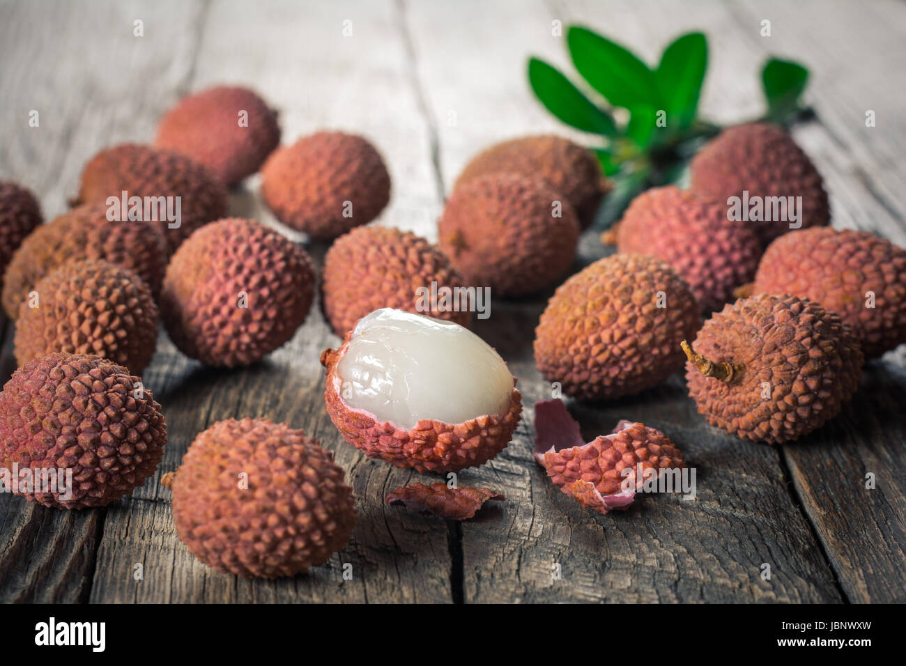 Lychees fruits on wooden background Stock Photo - Alamy