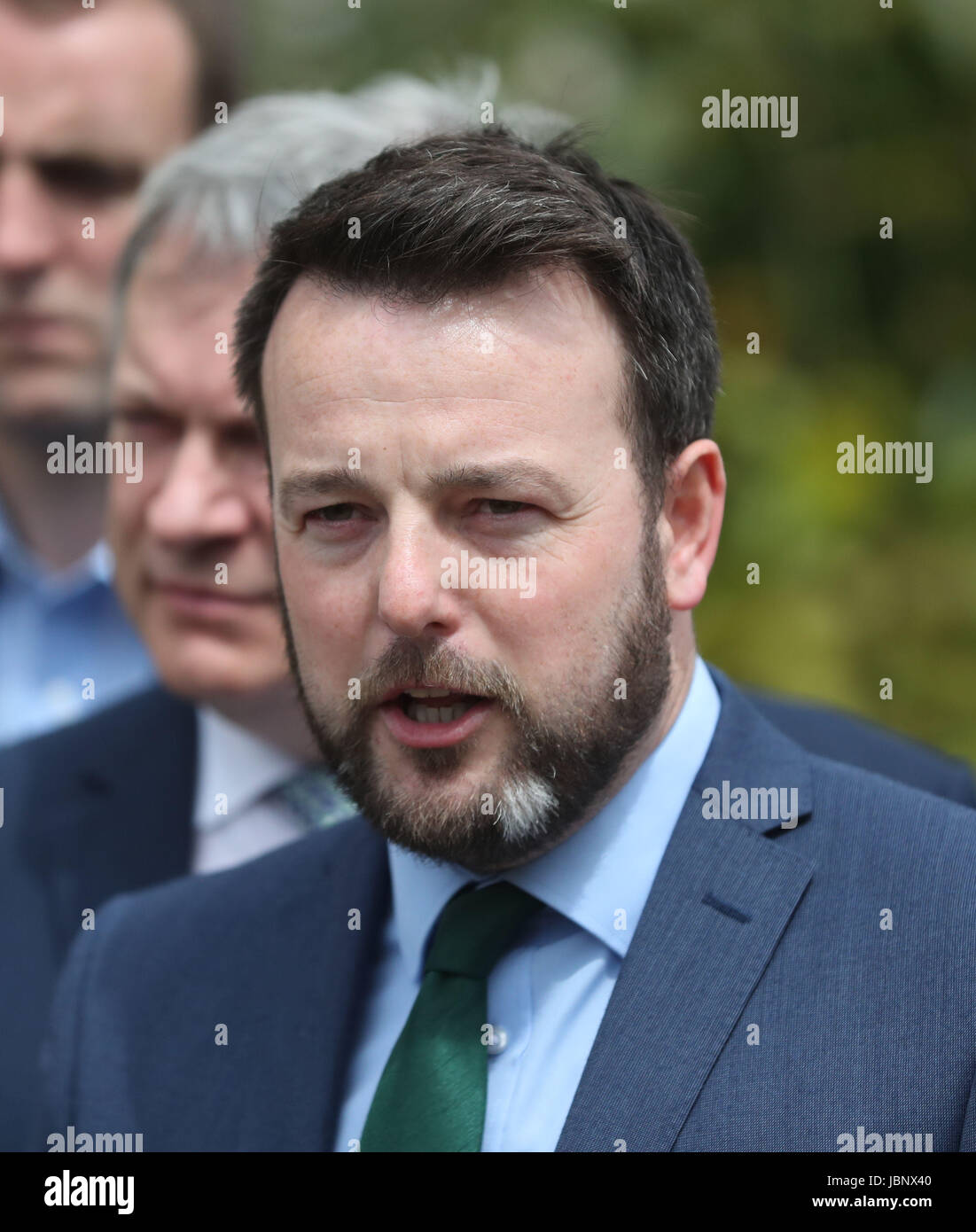 SDLP Leader Colum Eastwood speaks to the media flanked by party ...