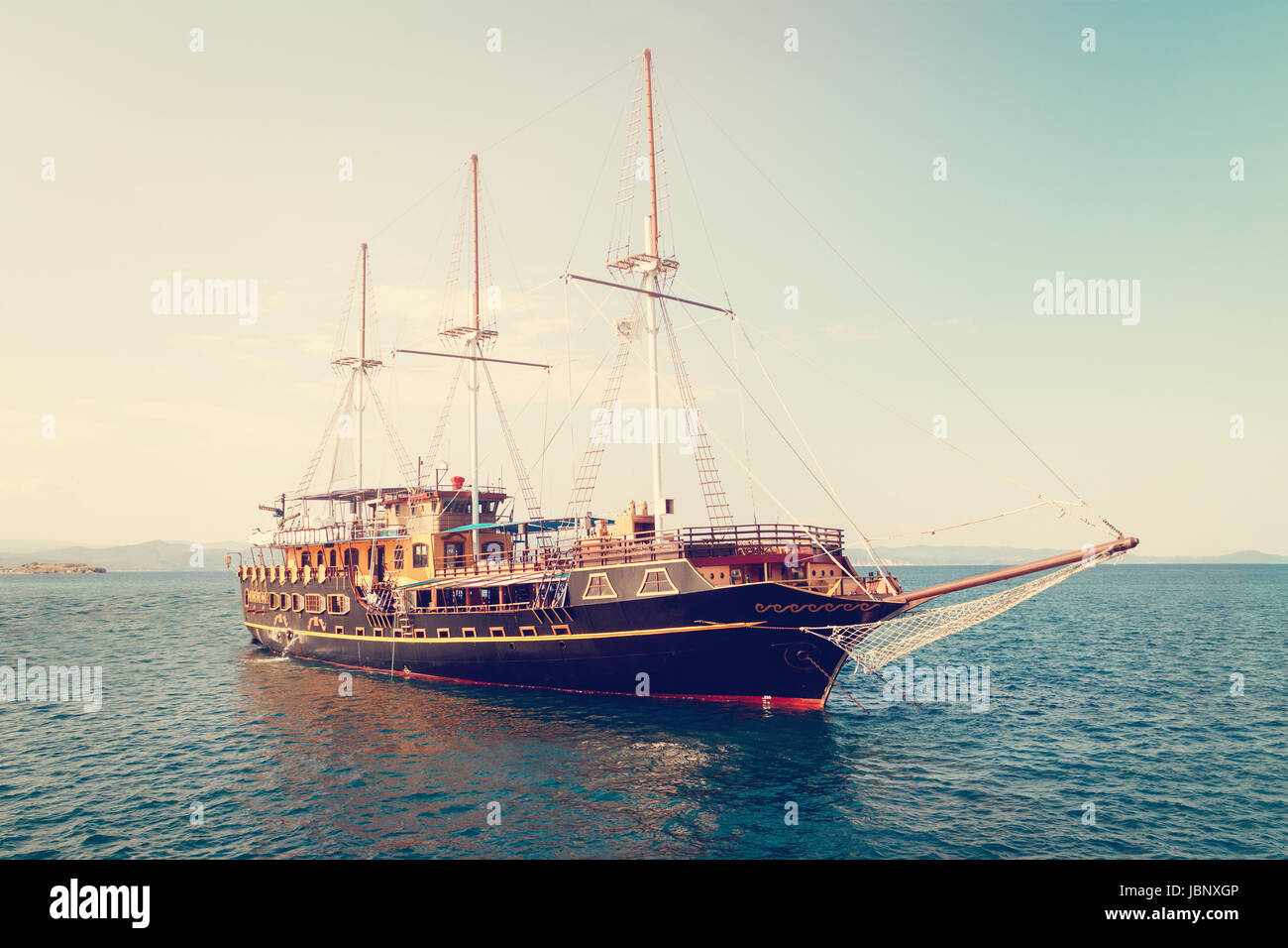 Sailing ship with down sails in the sea Stock Photo - Alamy