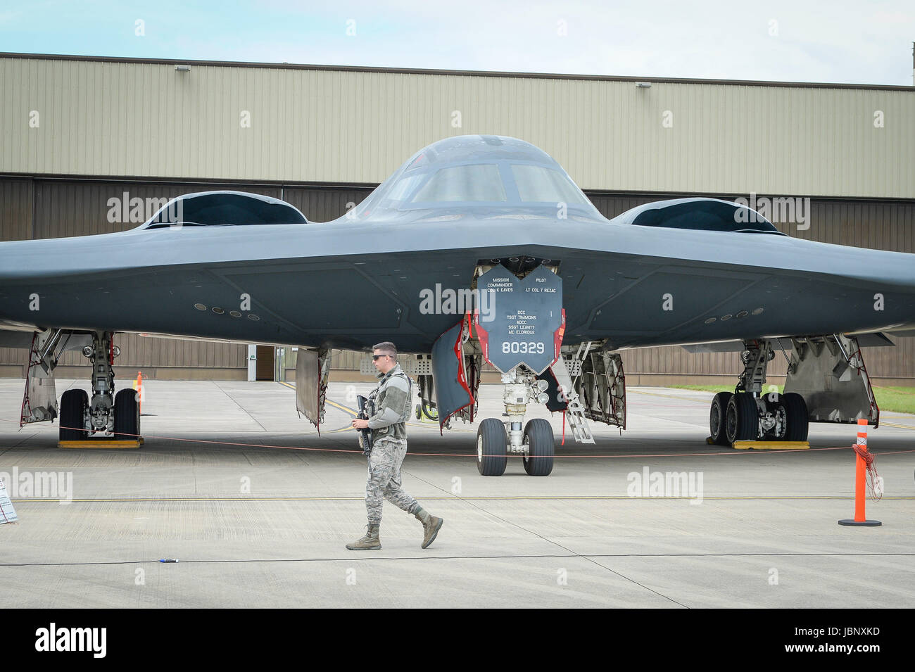 An armed guards patrols the perimeter of a USAF B-2 Spirit bomber at ...