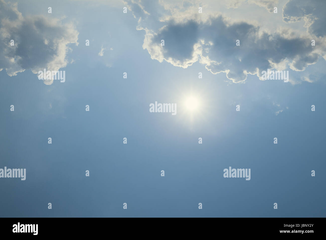 Sun in blue cloudy sky. Nature abstract background Stock Photo - Alamy