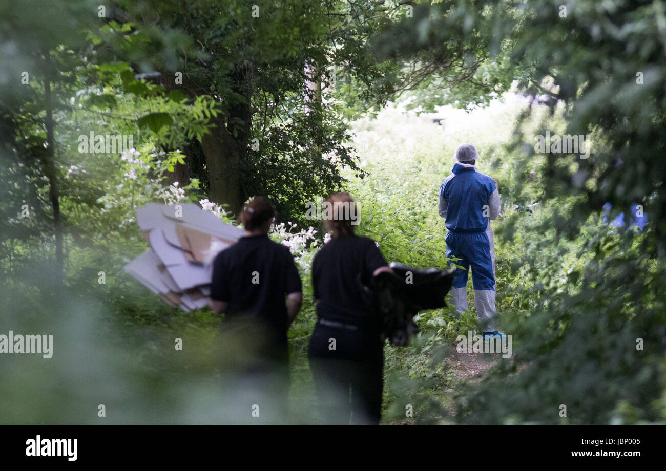 Thames Valley Police officers and forensic experts at the scene of a ...