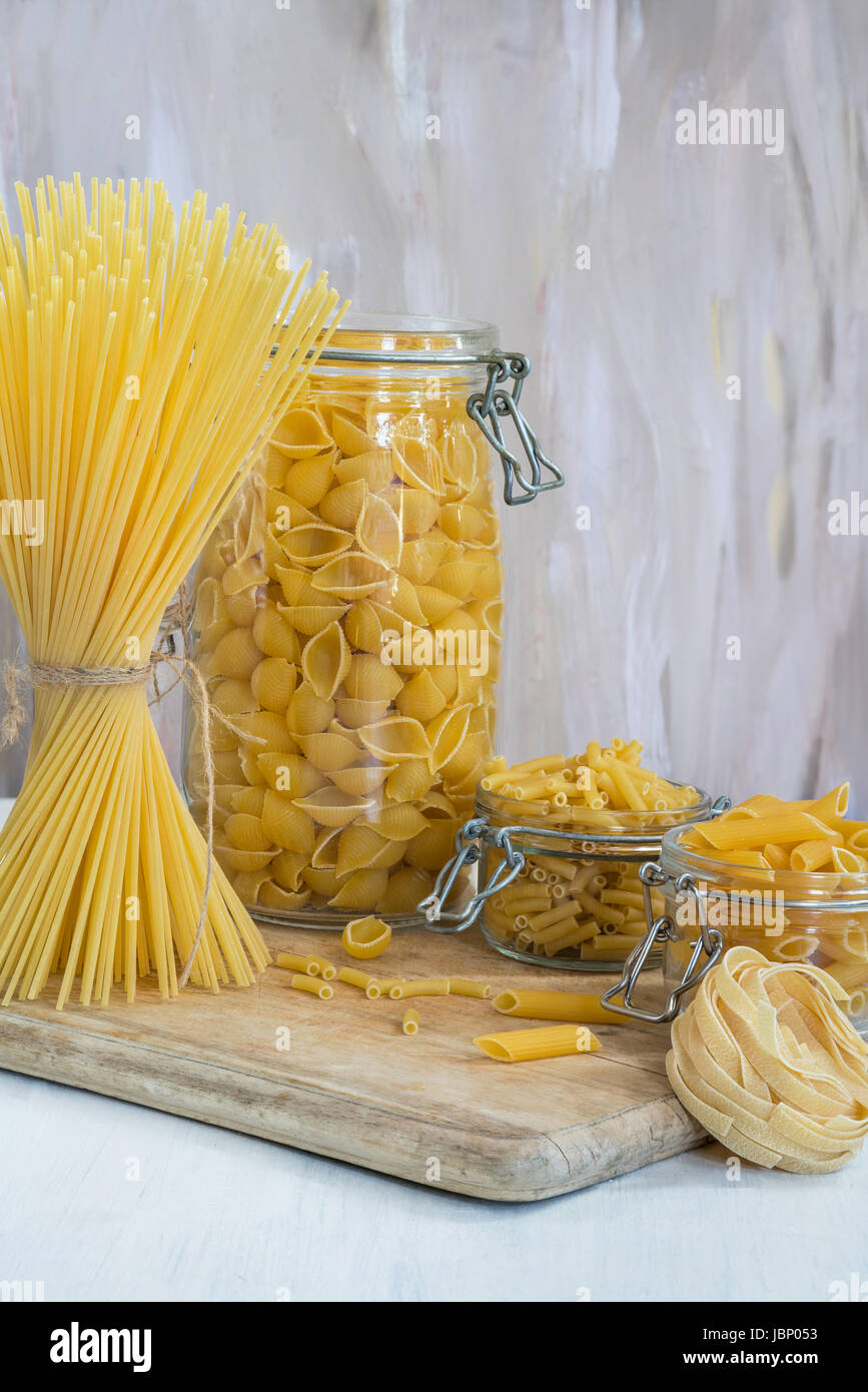 Assortment of pasta in jars pm wooden table Stock Photo - Alamy