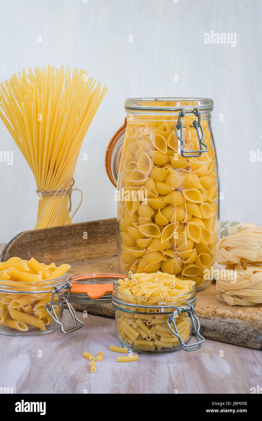 Assortment of pasta in jars pm wooden table Stock Photo - Alamy