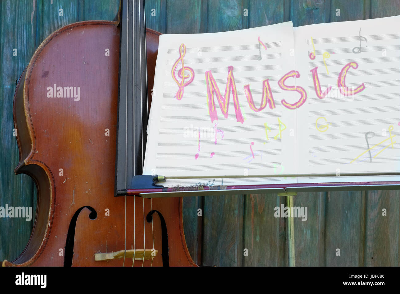Music stand with note sheets and written word Music, outdoor cropped ...